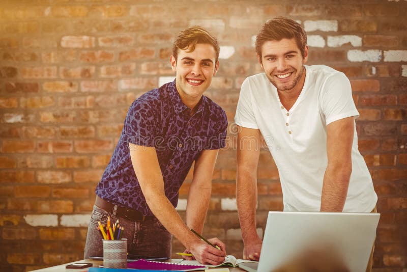 Composite Image of Smiling Creative Team Working Together Stock Photo ...