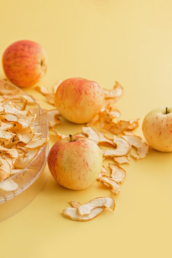 A Composition Against a Yellow Background Featuring Whole Apples and ...