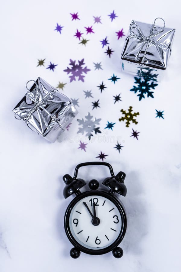 A Composition with an Alarm Clock and Stars, Snowflakes, Gifts on a ... A Composition with an Alarm Clock and Stars, Snowflakes, Gifts on a ...