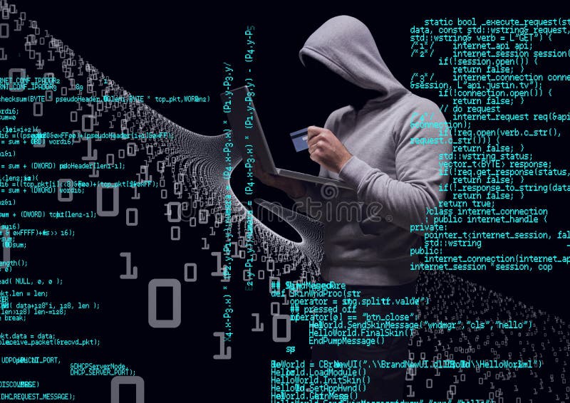 Hacker with Hood Holding a Credit Card and Using a Laptop in Frond of Wood Background with ...