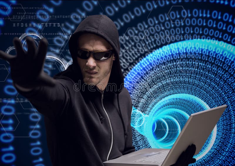 Hacker with Hood Holding a Credit Card and Using a Laptop in Frond of Wood Background with ...