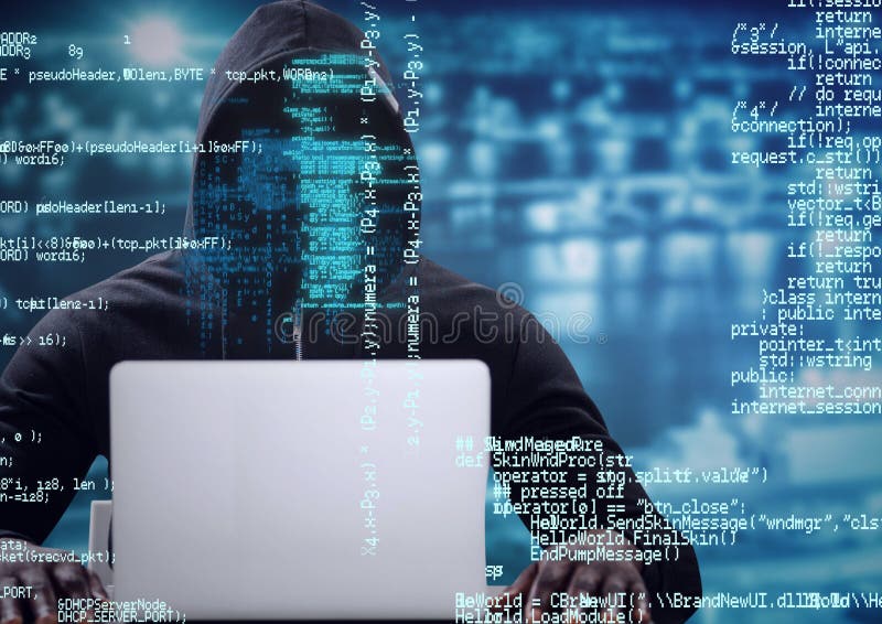 Hacker with Hood Holding a Credit Card and Using a Laptop in Frond of Wood Background with ...