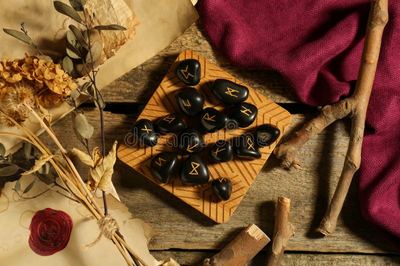 Composition with Black Rune Stones and Dried Plants on Wooden Table ...