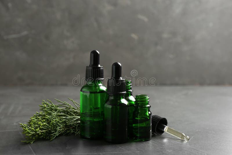 Composition with Bottles of Conifer Essential Oil on Grey Stock Photo ...
