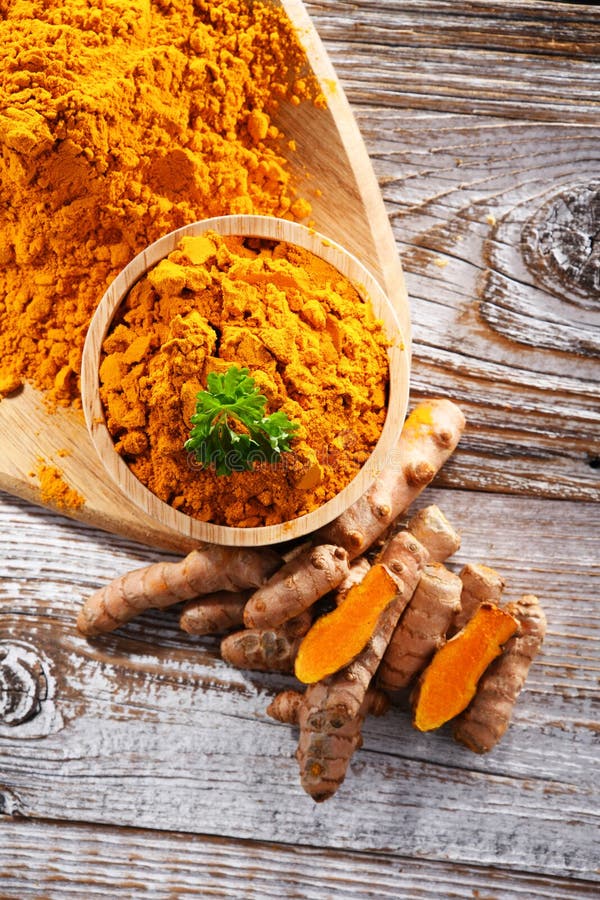Composition with a Bowl of Ground Turmeric and Its Fresh Rhizome Stock ...
