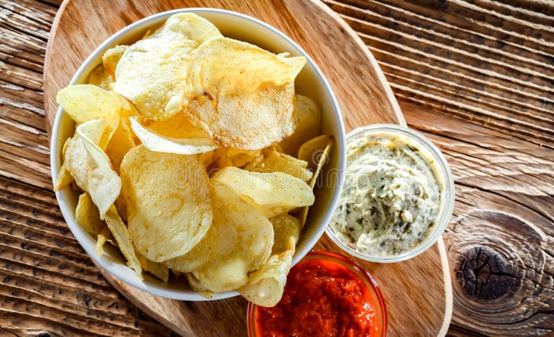 Composition with a Bowl of Potato Chips and Dipping Sauces Stock Image ...