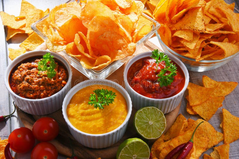 Composition with Bowl of Potato Chips Stock Photo - Image of salsa ...