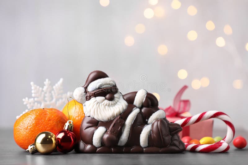 Composition with Chocolate Santa Claus, Sweets, Tangerine and Christmas ...