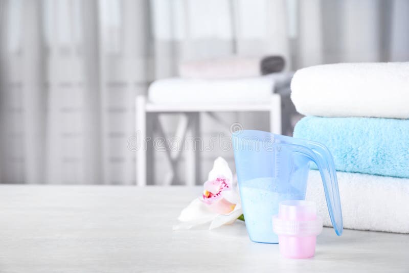 With Clean Towels and Laundry Detergents on Table Against Blurred ...
