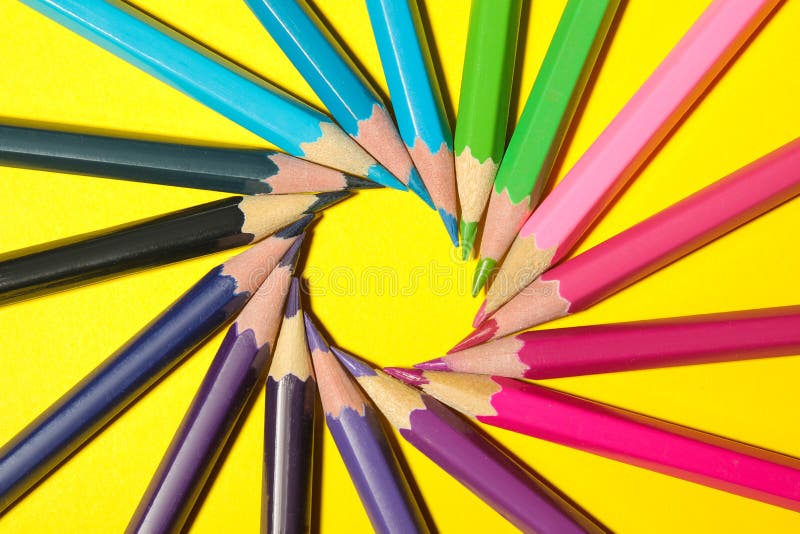 Composition with Colored Pencils on a Bright Yellow Background. Close ...