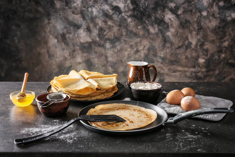 Composition with Delicious Thin Pancake on Dark Table Stock Image ...