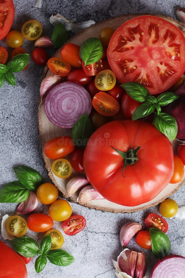 Composition of Different Tomatoes, Onion, Basil and Garlic Stock Photo ...