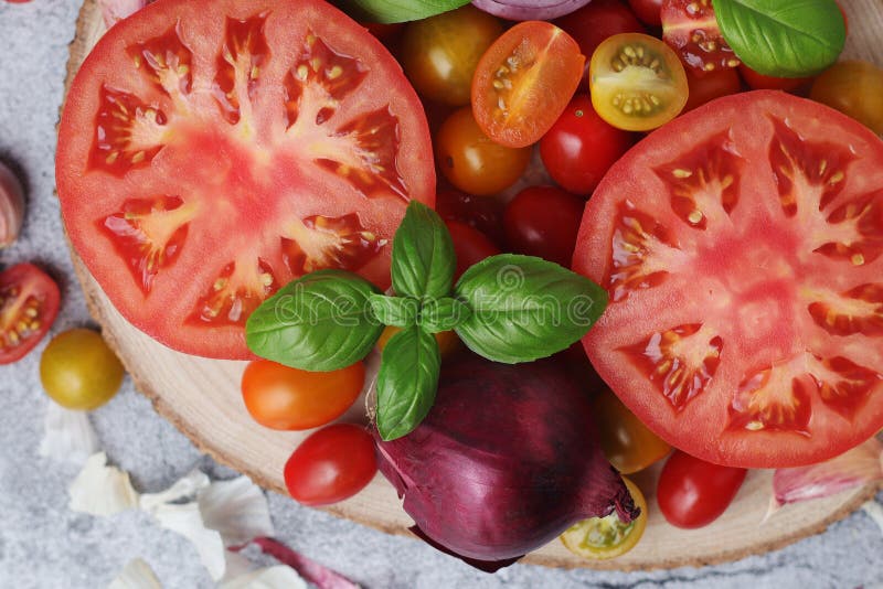 Composition of Different Tomatoes, Onion, Basil and Garlic Stock Photo ...