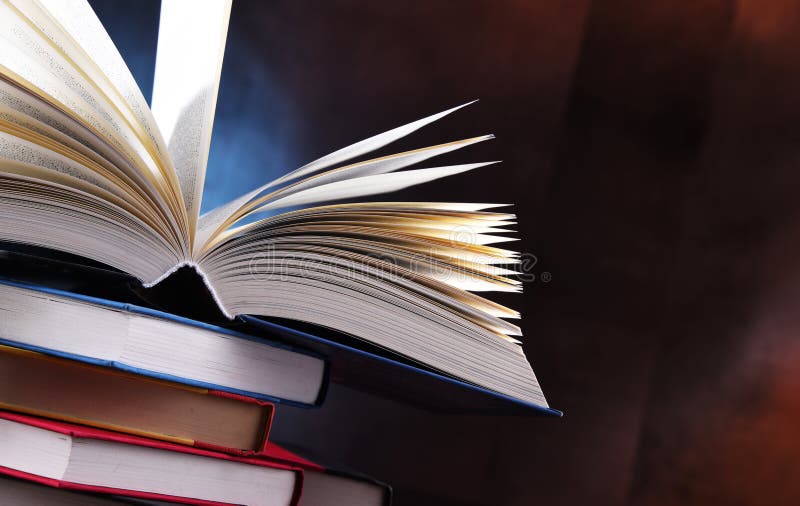 A Composition with an Open Book Lying on a Stack of Other Books Stock ...