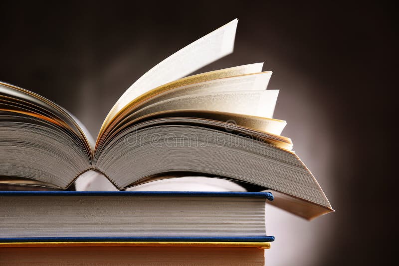 A Composition with an Open Book Lying on a Stack of Other Books Stock ...