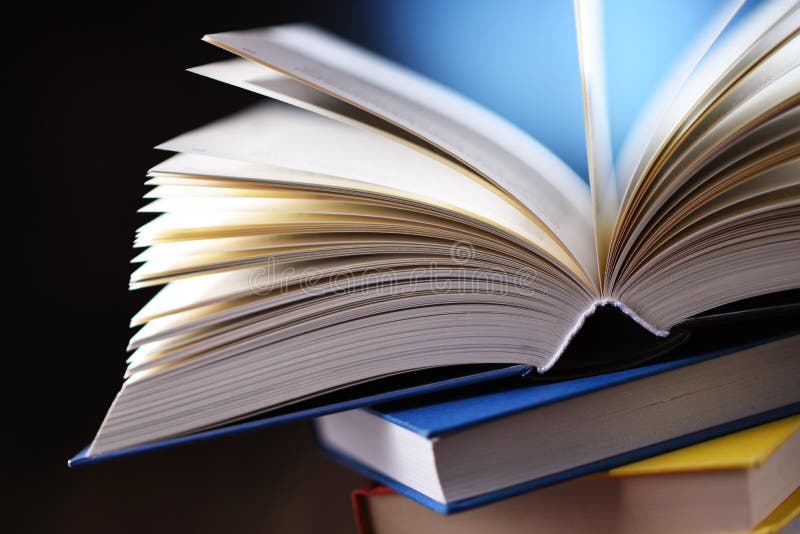 A Composition with an Open Book Lying on a Stack of Other Books Stock ...