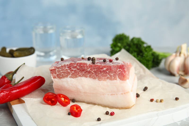 Composition with Pork Fatback and Spices on Table Against Blue ...