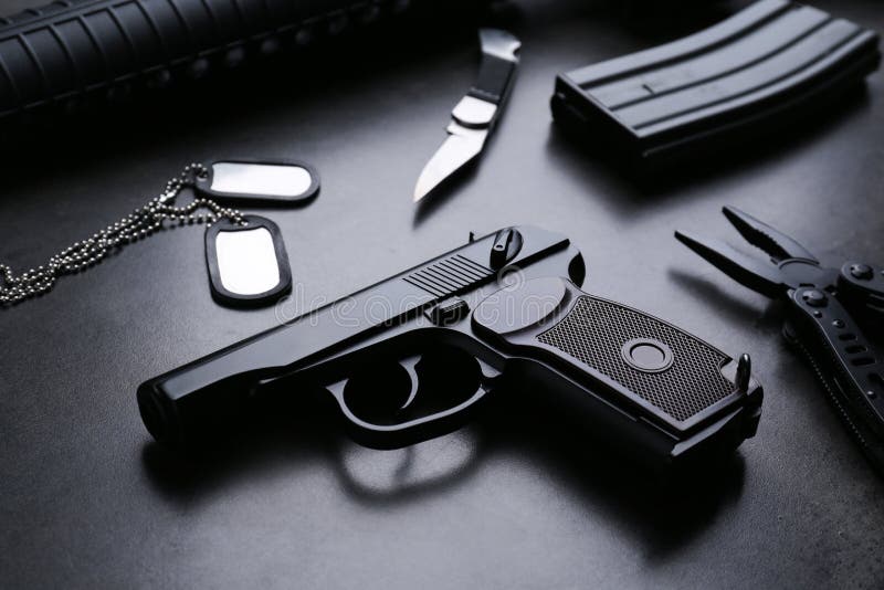 Composition with Professional Gun on Black Background Stock Photo ...