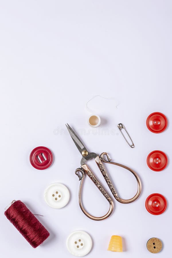 A Composition of Red Sewing Thread, Thimble, Vintage Scissors, Buttons ...