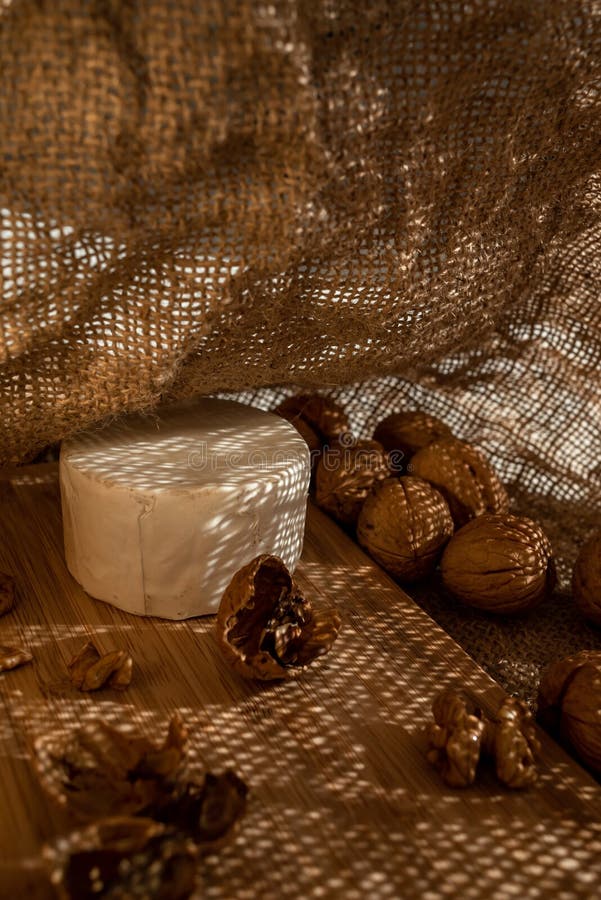 Composition of a Round Head of Cheese with White Mold and Walnuts on a ...