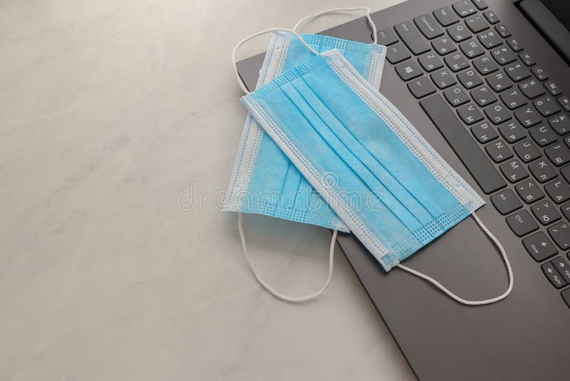 Composition with Safety Face Mask and Laptop on Light Background Stock ...
