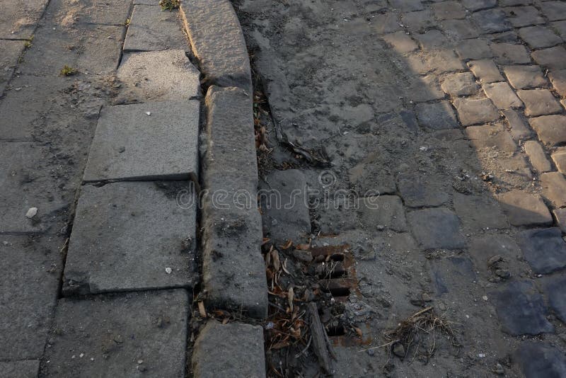 Composition of Sidewalk in Bad Condition, Cobblestones and a Clogged ...