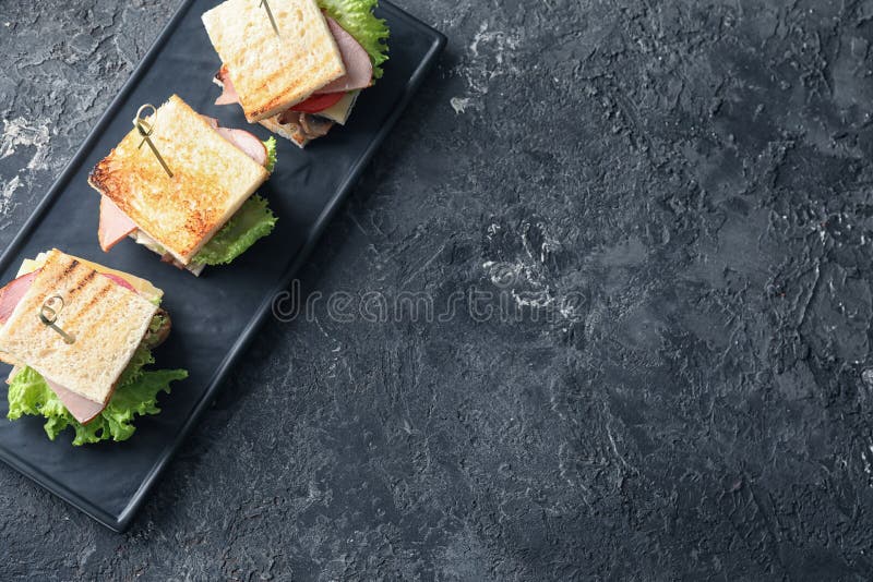 Composition with Tasty Sandwiches on Textured Table Stock Photo - Image ...