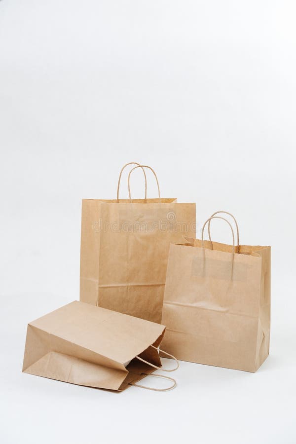 Three Empty Brown Paper Bags and Paper Plant Bed Over White Background ...