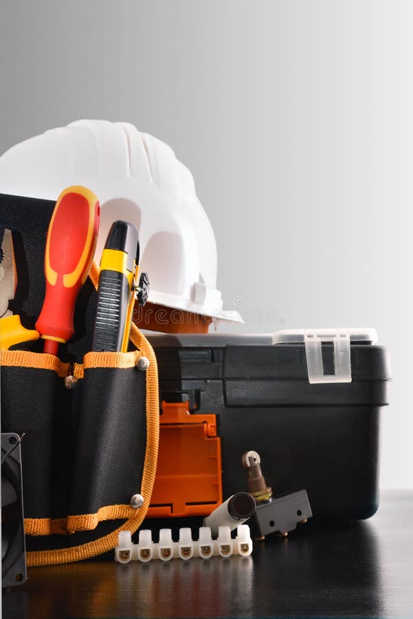 Composition with Tools and Electrical Equipment on Black Table Vertical ...