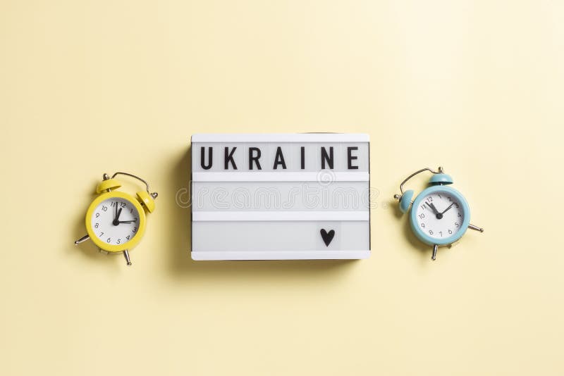 A Composition with a Vintage Clock and a Lamp with the Inscription ...