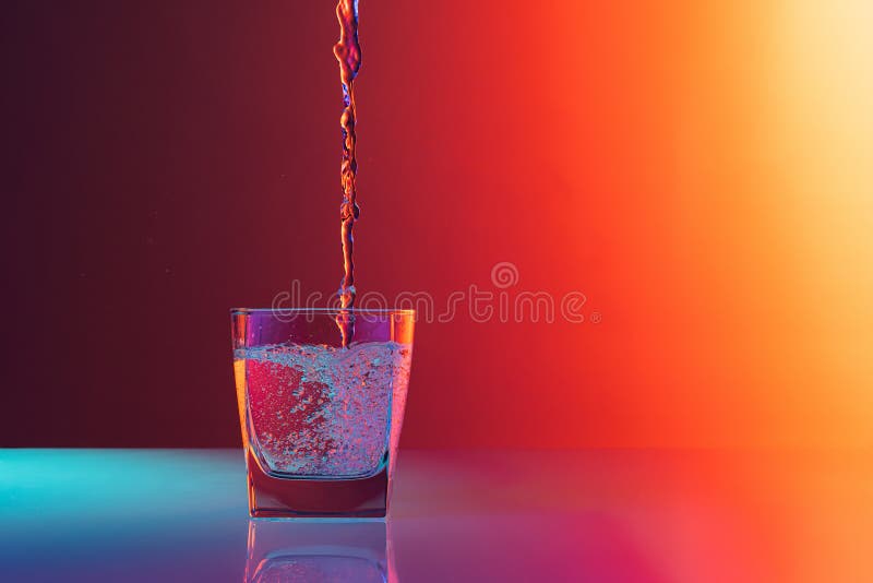 Composition with Water Flows into Glass Placed on Table Over Gradient ...