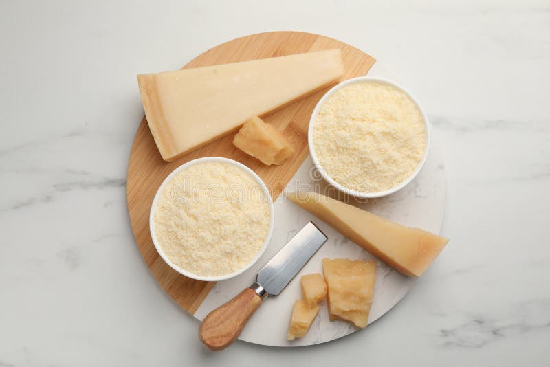 Composition with Whole and Grated Parmesan Cheese on White Marble Table ...