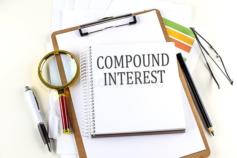 COMPOUND INTEREST Text on Notebook with Clipboard on White Background ...