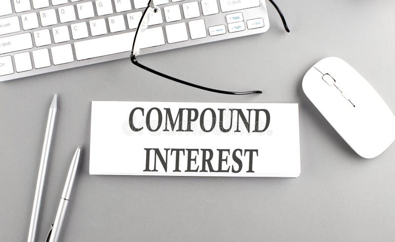COMPOUND INTEREST Text on Paper with Keyboard on Grey Background Stock ...