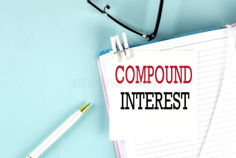 COMPOUND INTEREST Text on a Sticky on Notebook with Pen and Glasses ...