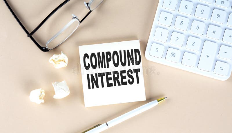COMPOUND INTEREST Text on Sticky with Pen ,calculator and Glasses on ...