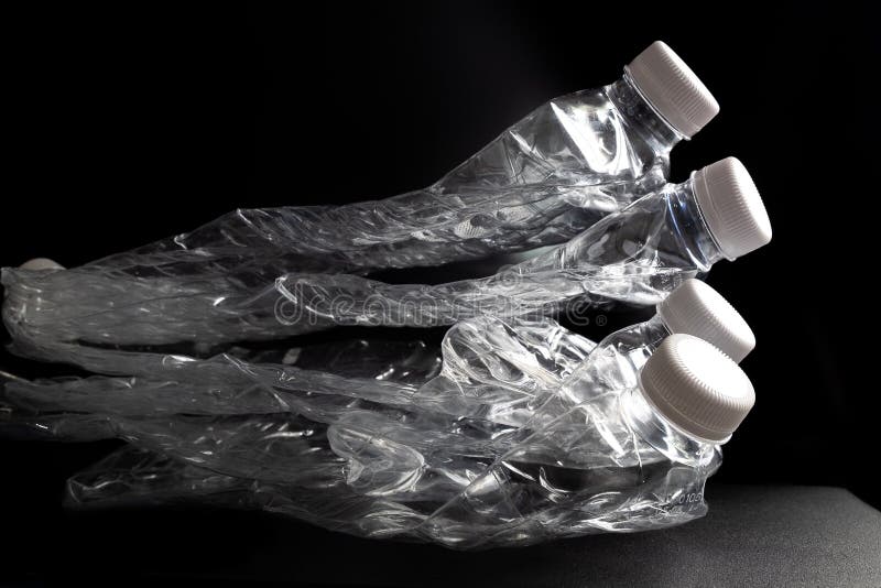 Compressed Plastic Drinking Water Bottle on ISolated Black Background ...