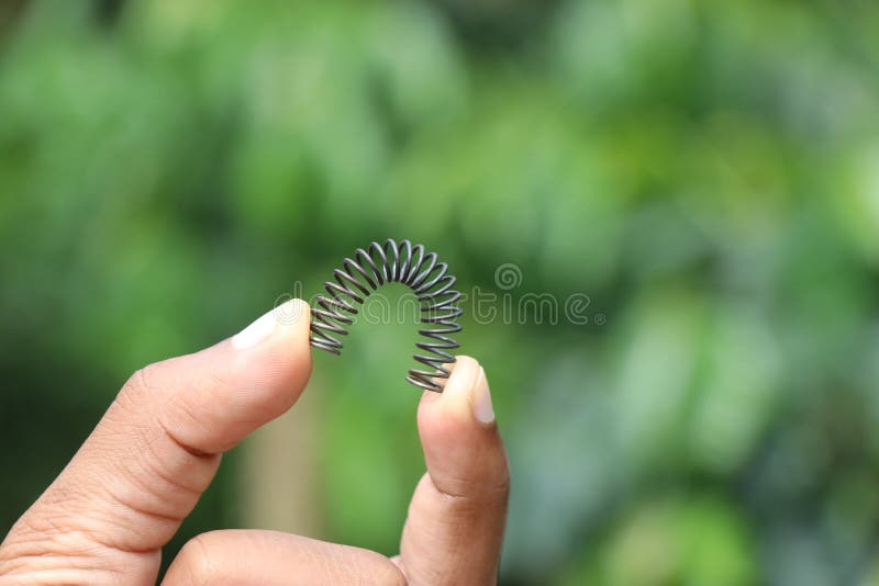 Compression Springs Made of Metal Holding in Hand, Metal Springs are ...