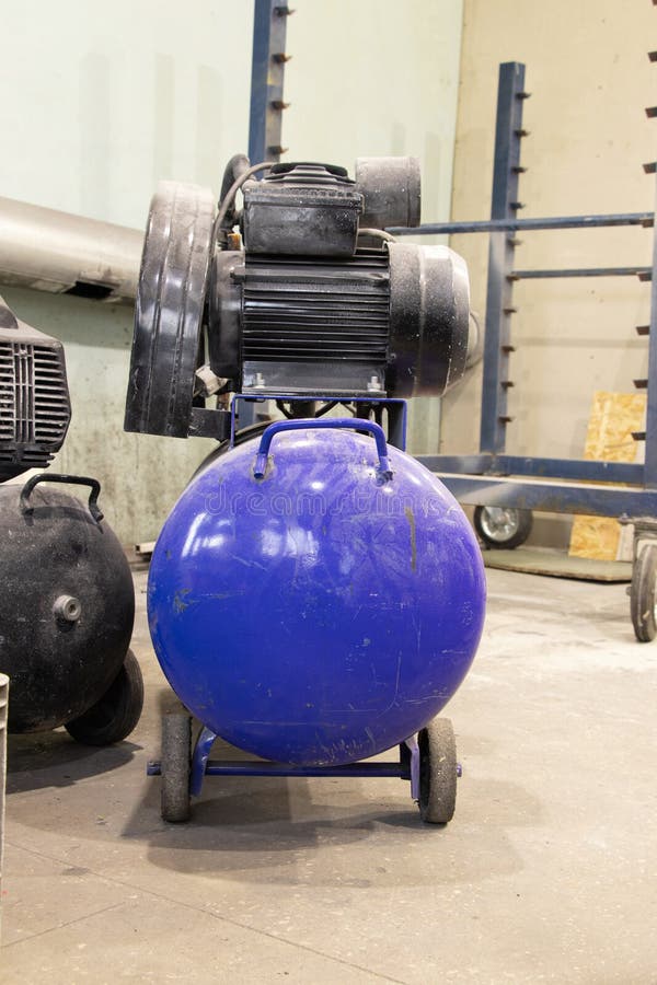 The Compressor is on the Floor in the Painter S Workshop, the Working ...