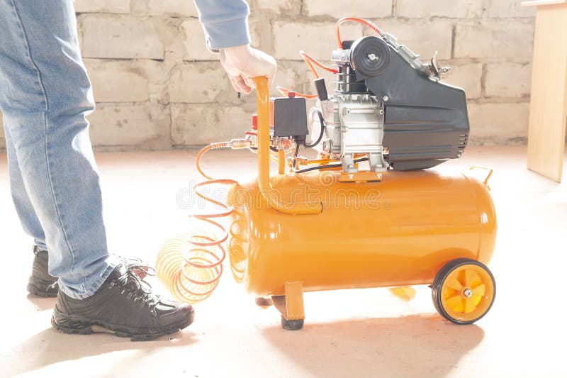 The Compressor is Portable.Using a Portable Compressor at Work Stock ...