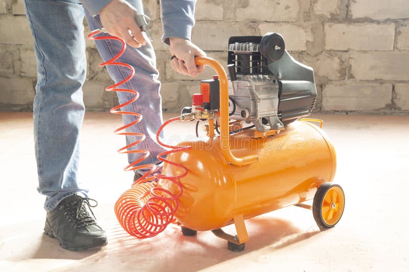 The Compressor is Portable.Using a Portable Compressor at Work Stock ...