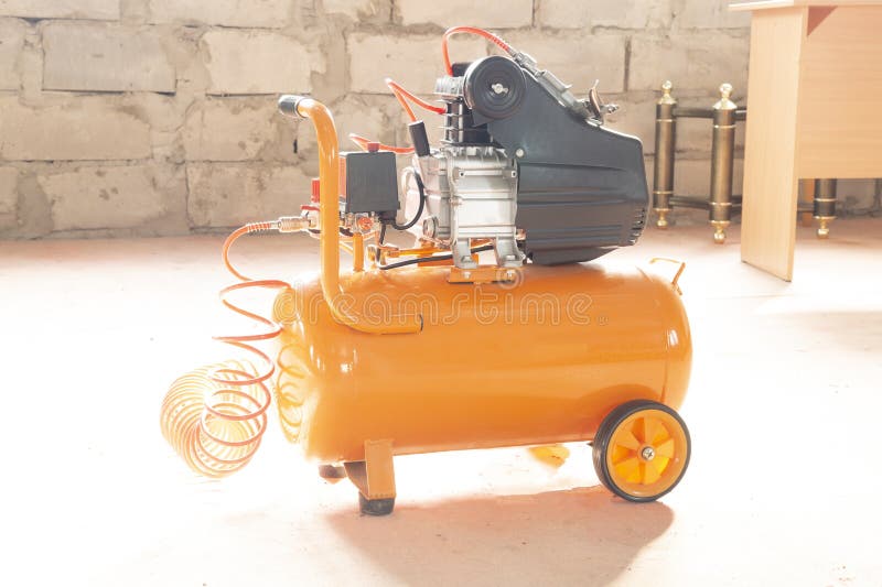 The Compressor is Portable.Using a Portable Compressor at Work Stock ...