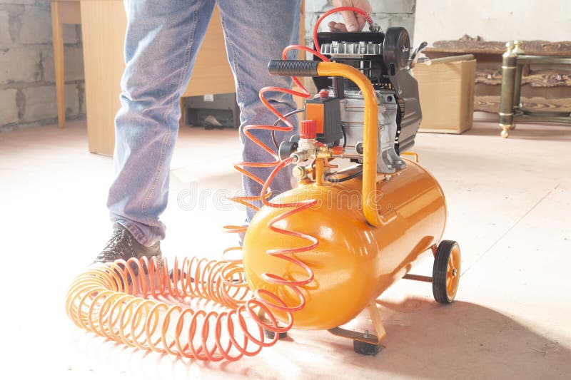 The Compressor is Portable.Using a Portable Compressor at Work Stock ...