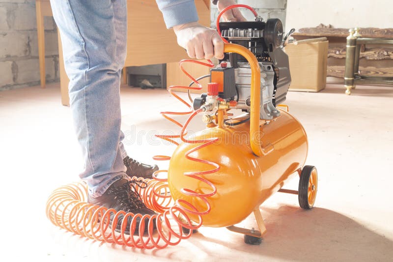The Compressor is Portable.Using a Portable Compressor at Work Stock ...