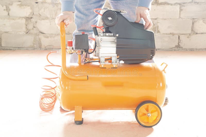 The Compressor is Portable.Using a Portable Compressor at Work Stock ...