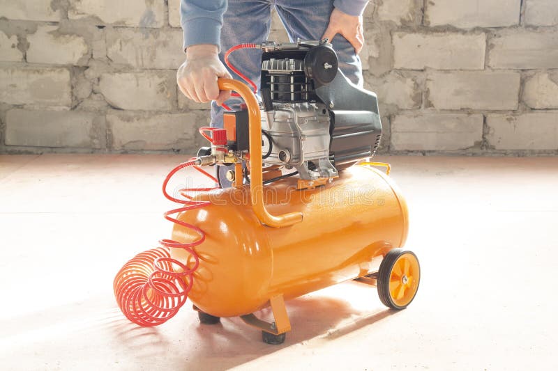The Compressor is Portable.Using a Portable Compressor at Work Stock ...