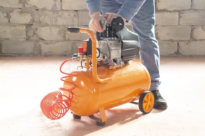 The Compressor is Portable.Using a Portable Compressor at Work Stock ...