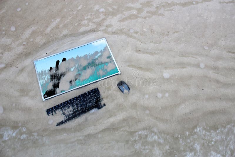 The Computer on a Beach with a Hand Images on the Screen. Stock Photo ...