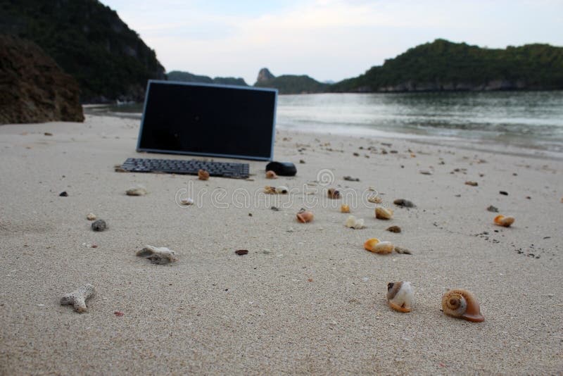 The computer on the beach. stock image. Image of display - 84912749