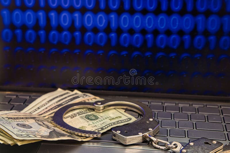 Computer with Binary Data on the Screen, Handcuffs and Money on the ...
